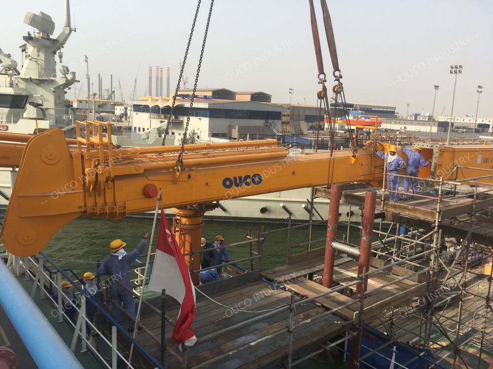 seaworkers are assembling marine cranes