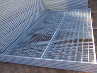 Many welded temporary fencing panels with square frame and square top lying on the floor neatly.